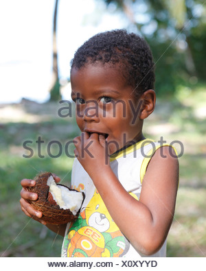 Creole, boy eating a coconut, southern Mahe, Mahe, Seychelles Stock ...