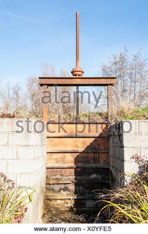 Irrigation Canal and old and manual Flood gate valve Stock Photo ...