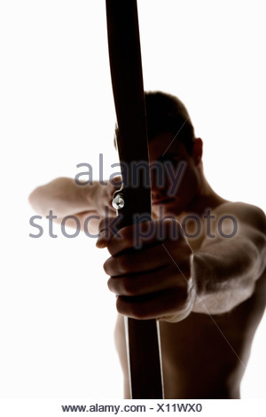 Silhouette of archer pulling an arrow back on his longbow Stock Photo ...