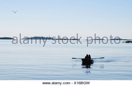 Silhouette of a couple in a rowing boat at sunset, Russia Stock Photo ...
