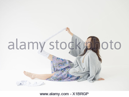 Young woman taking off socks Stock Photo - Alamy