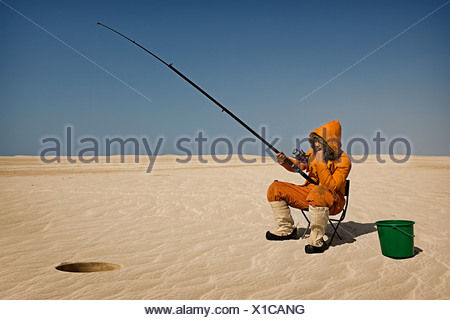 Eskimo fishing in desert Stock Photo - Alamy