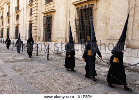 Penitent dressed in black penitential robe (nazareno) on their way to ...