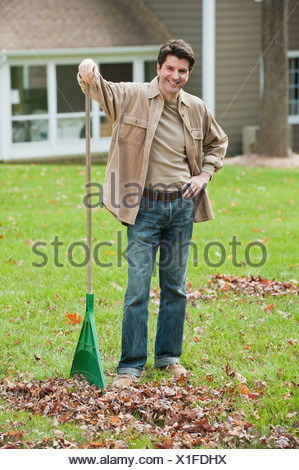 Man raking the lawn Stock Photo - Alamy