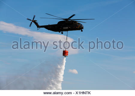 Fire fighting helicopter carrying water bag Stock Photo: 28608530 - Alamy