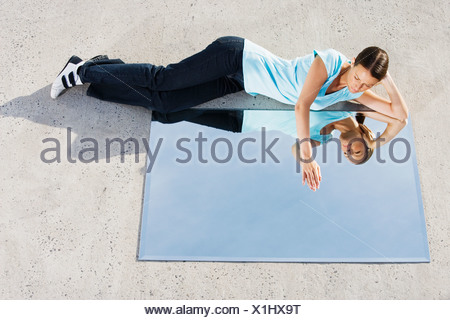 Young woman lying on the ground Stock Photo: 72547336 - Alamy