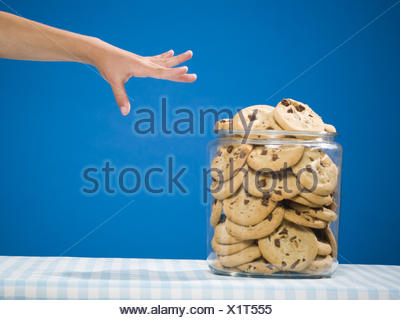 Girl reaching into cookie jar Stock Photo: 18612014 - Alamy