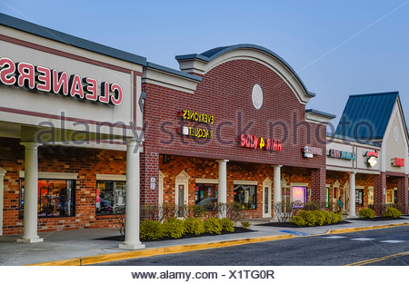 Typical American shopping center or strip mall wide view with traffic ...