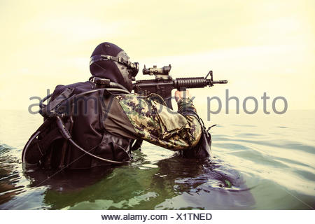 U.S. Navy Seal combat diver equipped with night vision, prepares for ...