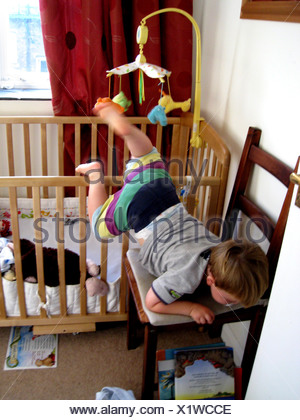 toddler climbing out of crib onto a chair Stock Photo: 52853212 - Alamy