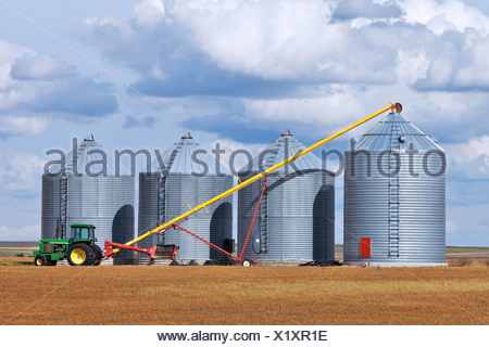 Grain auger and tractor ready to fill silo, Assiniboia, Saskatchewan ...