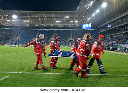 Injured football player being carried off the field by attendants Stock ...
