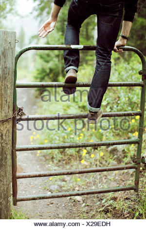 Man climbing over barrier Stock Photo: 74108840 - Alamy