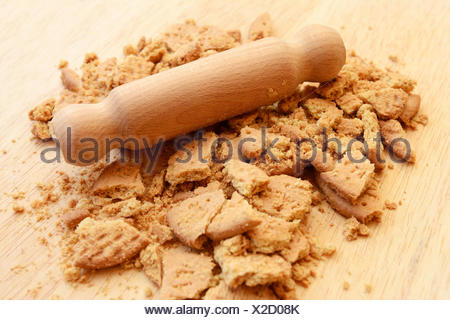 Crushing digestive biscuits into small pieces and crumbs with a Stock ...