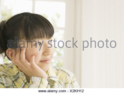 Teenage girl resting cheek on hand Stock Photo: 54641825 - Alamy