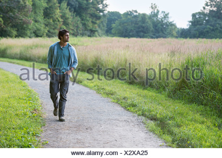 A person walking down a path in a parking lot in the new england area ...