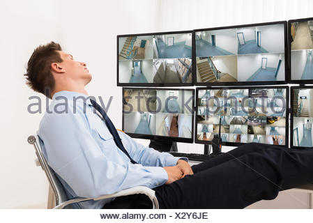 Security guard sleeping in surveillance room Stock Photo - Alamy