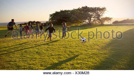 Primary schoolchildren playing in a school playground at break time ...