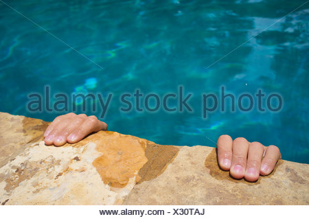 USA, Texas, Human hands grabbing edge of swimming pool Stock Photo - Alamy