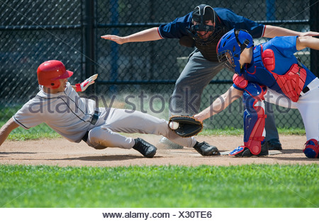 Baseball player sliding into home plate Stock Photo: 20250593 - Alamy