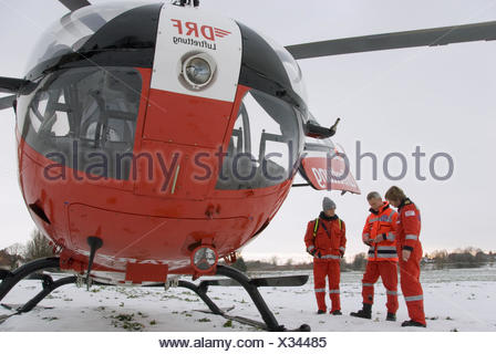 a rescue helicopter in snow covered mountains used to transport injured ...