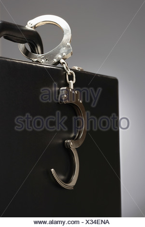 Handcuffs Attached to Briefcase Stock Photo: 5027720 - Alamy