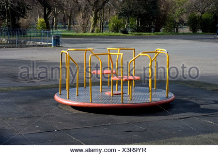Children's play area roundabout merry-go-round. Old worn weathered ...