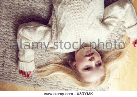 Young girl lying on rug Stock Photo: 61737785 - Alamy