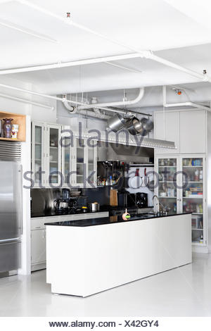 Open plan white modern kitchen with custom made table of lime and oak ...