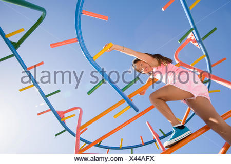 Girl climbing on monkey bars at a playground Stock Photo: 41269546 - Alamy