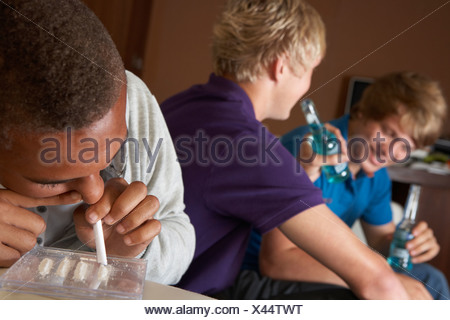 Group Of Teenage Boys Taking Drugs At Home Stock Photo - Alamy