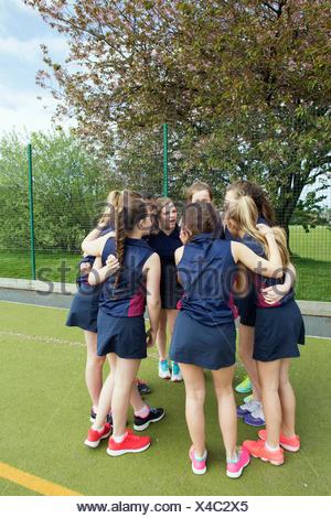 Group of girls in huddle on sports field Stock Photo: 87293259 - Alamy