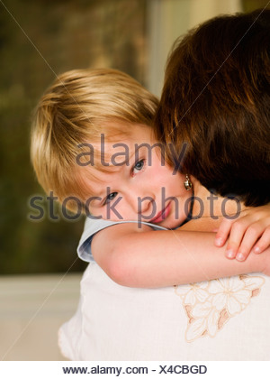 Mother hugging sad son Stock Photo - Alamy
