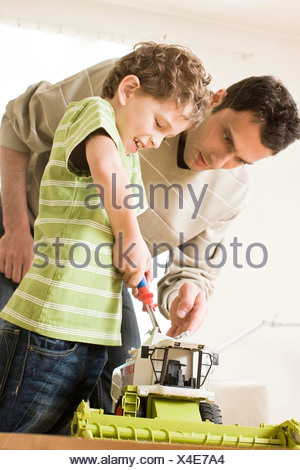 boy playing fixing toy car as mechanic in his bedroom Stock Photo ...