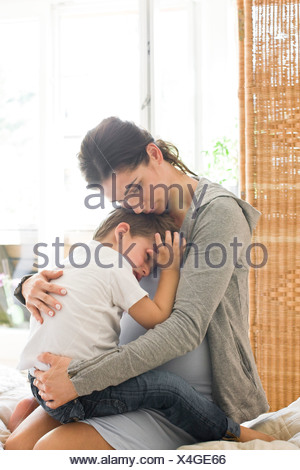 Mother hugging sad son Stock Photo - Alamy