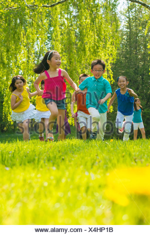 Children running on grass Stock Photo - Alamy
