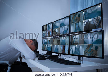 Security guard sleeping at desk Stock Photo - Alamy