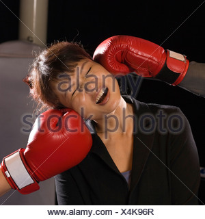 Young woman being hit by her opponent in a boxing ring Stock Photo ...