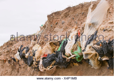 old landfill rubbish revealed in sea cliffs by coastal erosion on ...