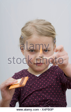 Young child playing with matches Stock Photo: 27804275 - Alamy