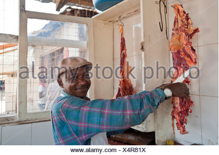 Butcher cutting meat, African man, Tanzania, Africa Stock Photo - Alamy