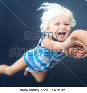 Toddler being spun around Stock Photo - Alamy