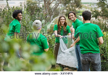 young people collecting empty plastic bottles for recycling Stock Photo ...