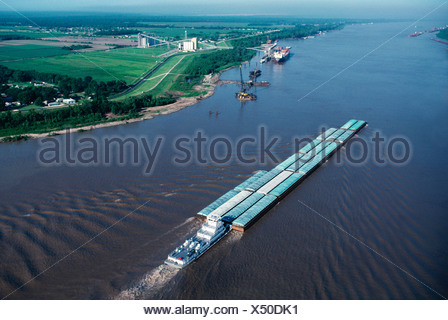 Agriculture - Grain barge navigating the Mississippi River early on ...