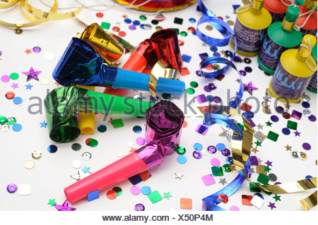 A still life image of colourful confetti, horn blowers, streamers and ...