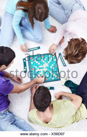 Four young people playing scrabble Stock Photo - Alamy