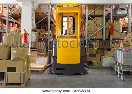 High rack stacker forklift truck in warehouse rows Stock Photo - Alamy