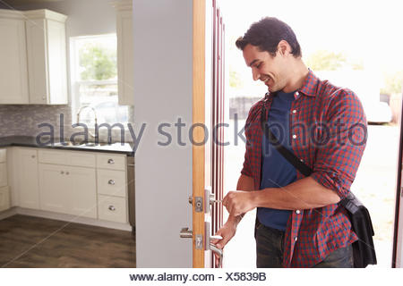 Man Coming Home From Work And Opening Door Of Apartment Stock Photo ...