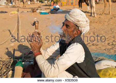 Indian man with a turban smoking a hash pipe, Pushkar, Rajasthan Stock ...