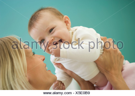 Mother picking up baby from crib Stock Photo: 59044662 - Alamy